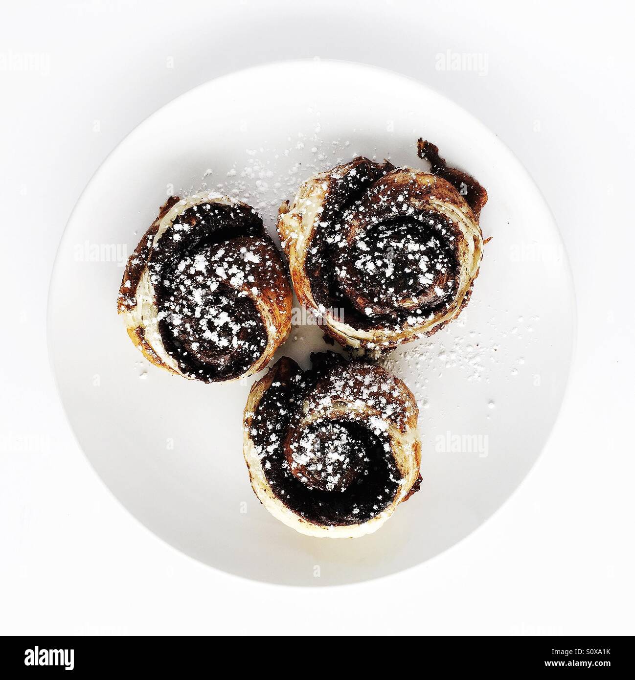 Freshly baked cocoa filled pastries on a white plate Stock Photo - Alamy