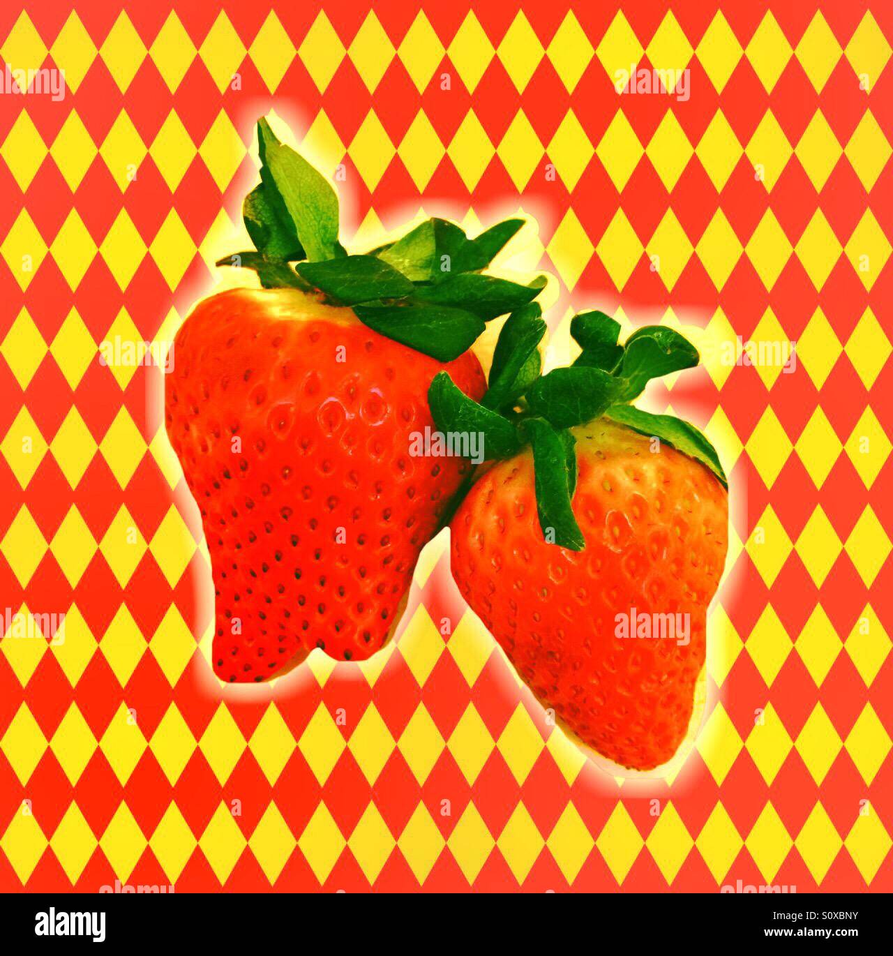 A bright whimsical photo of two red strawberries on a background of red ...