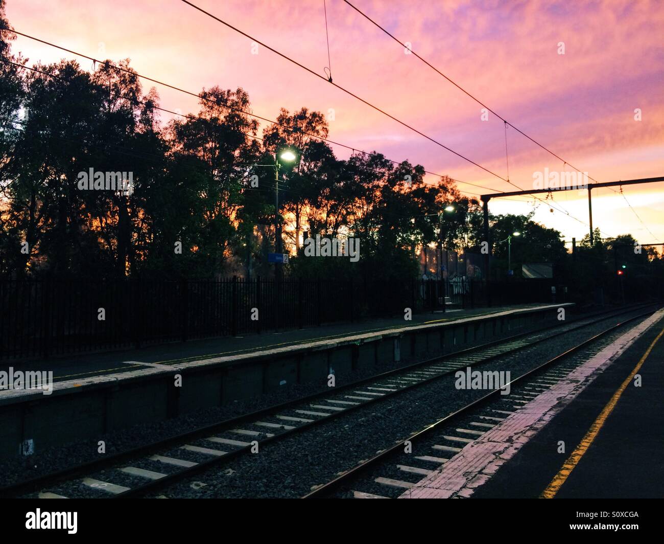 Train line at dawn Stock Photo - Alamy