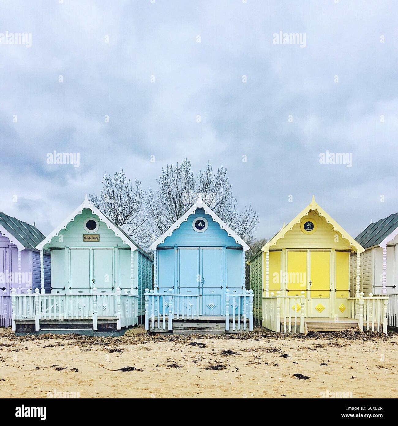 Pastel coloured beach huts in West Mersea seafront Stock Photo - Alamy