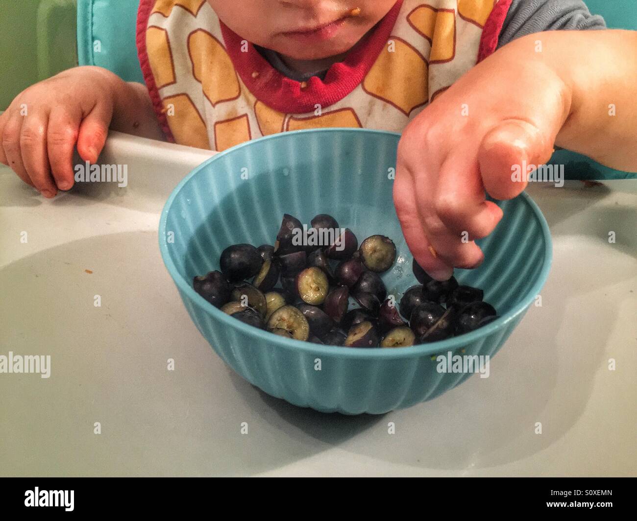 Baby eating alone hi-res stock photography and images - Alamy