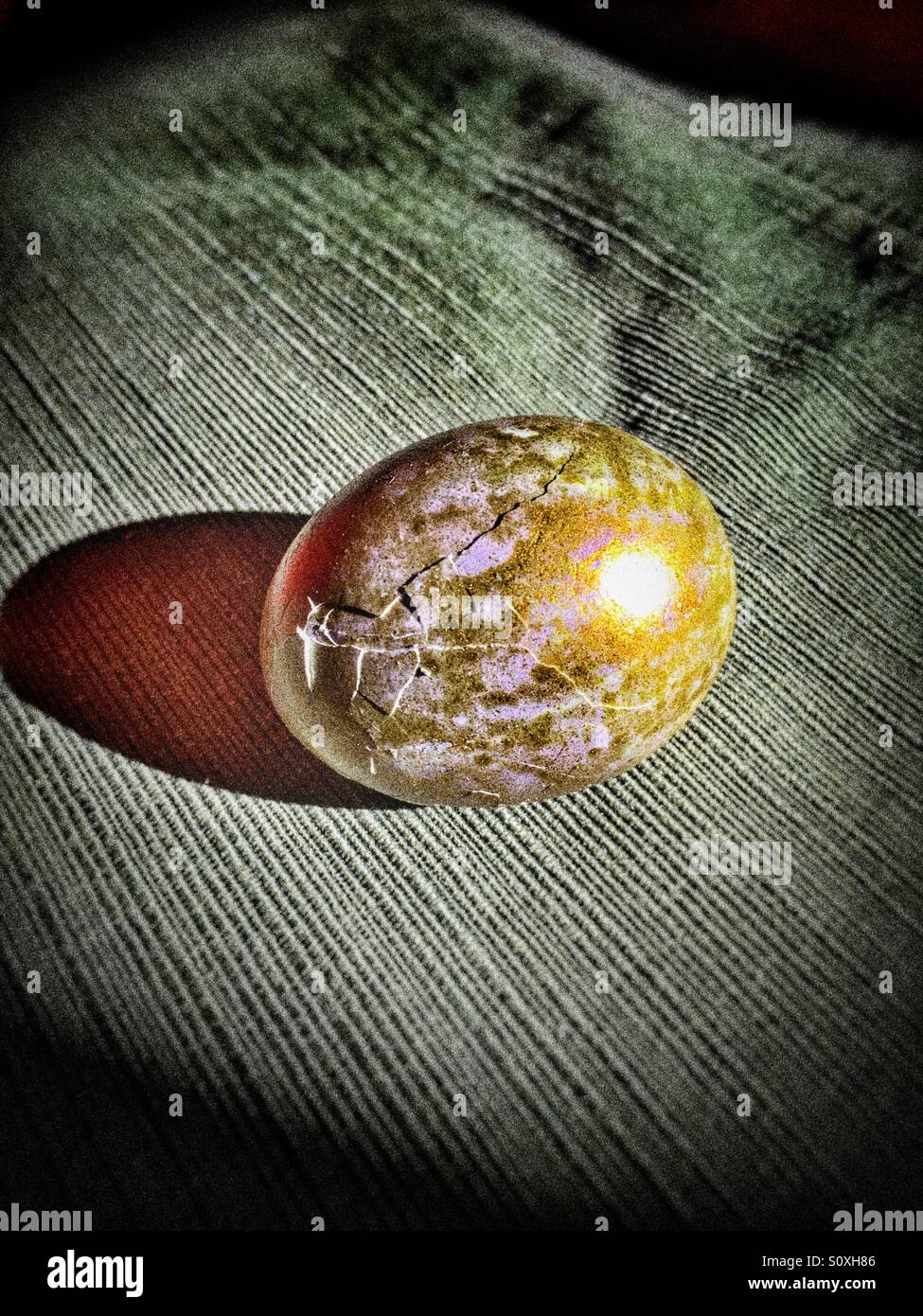 Cracked golden egg Stock Photo - Alamy