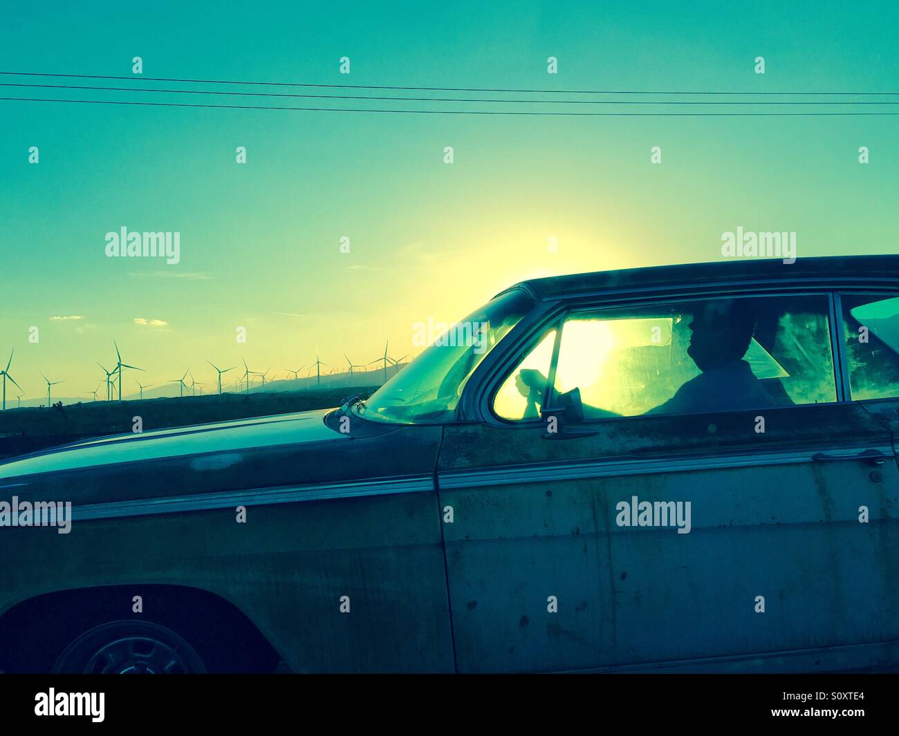 Driving at sunset Stock Photo - Alamy