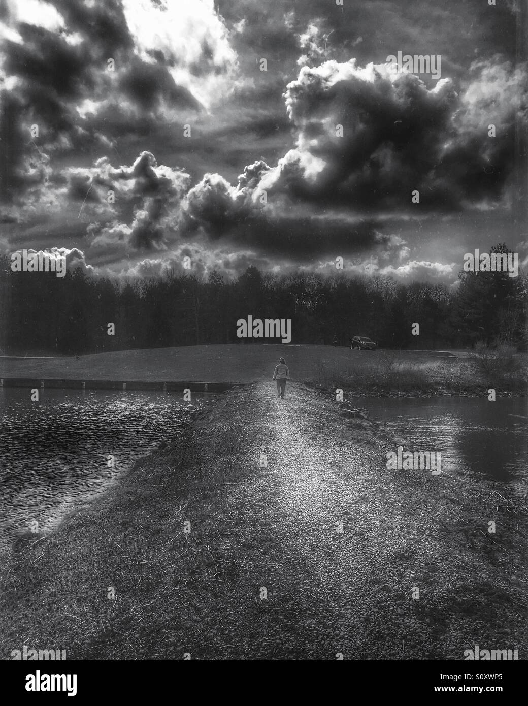 A woman walking into a storm Stock Photo - Alamy