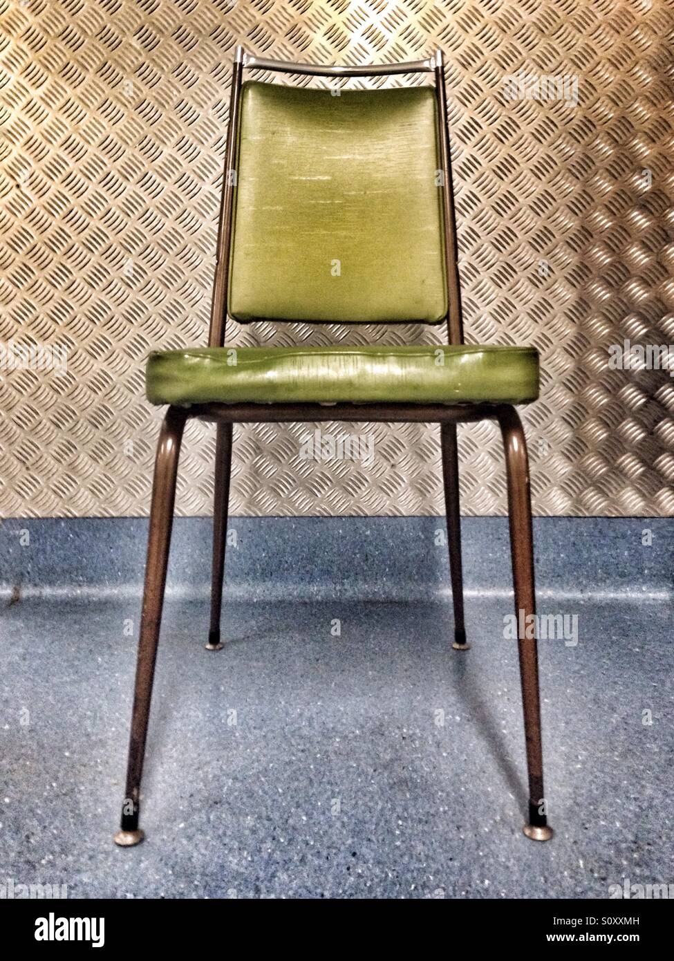 Chair against a wall Stock Photo - Alamy