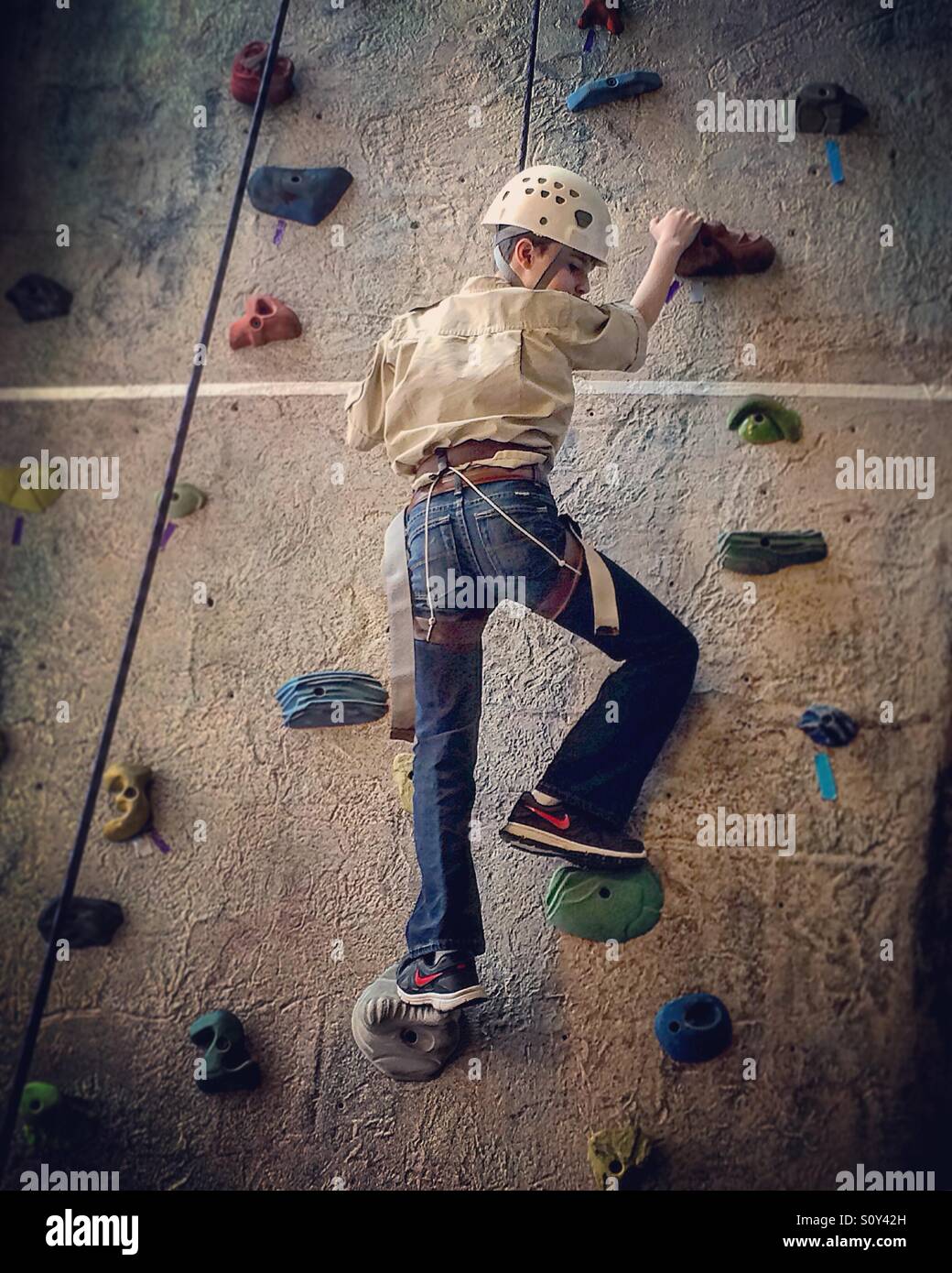 A Boy Scout on a climbing wall Stock Photo - Alamy