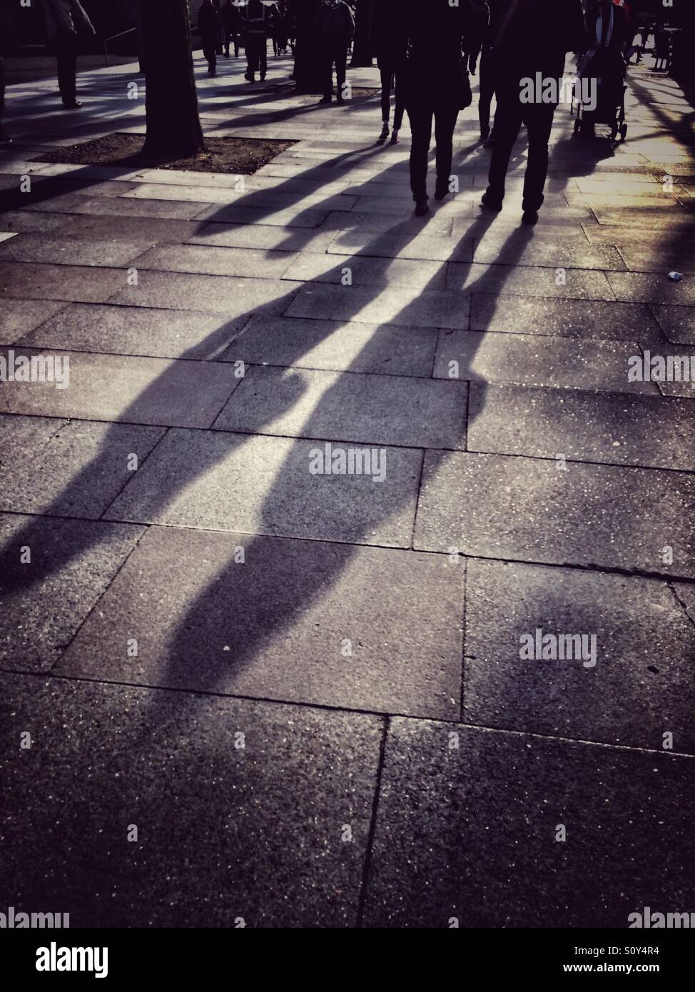 Shadows of people walking Stock Photo - Alamy