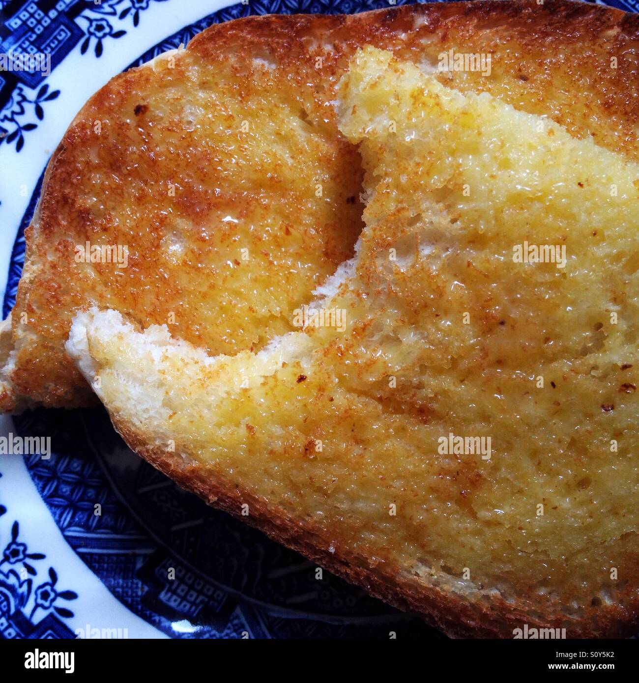 A bite out of a piece of toast Stock Photo - Alamy