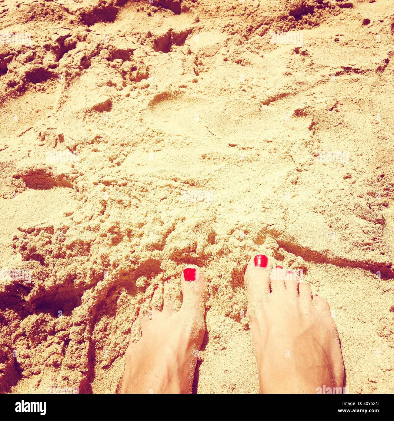 Feet in the sand Stock Photo - Alamy