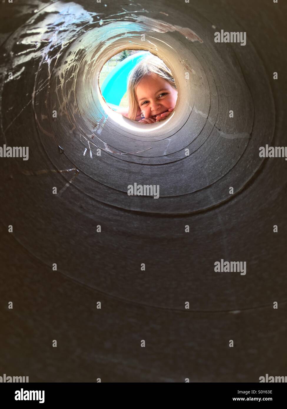 Girl looking through tube hi-res stock photography and images - Alamy