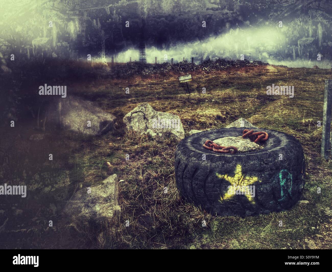 Dumped tyre in wasteland Stock Photo - Alamy