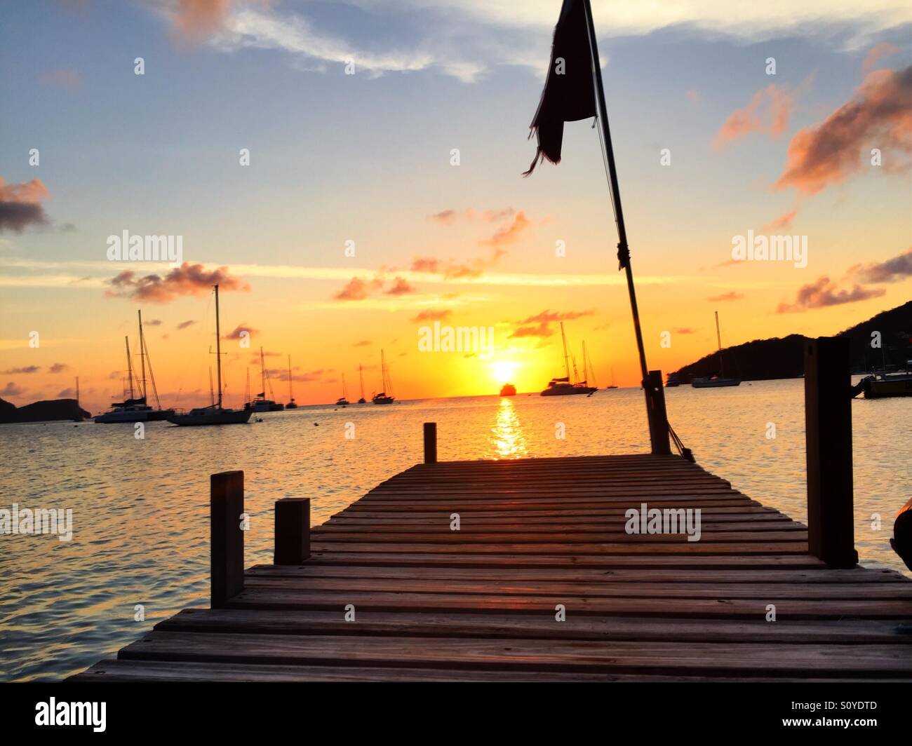Dock with golden setting sun Stock Photo - Alamy