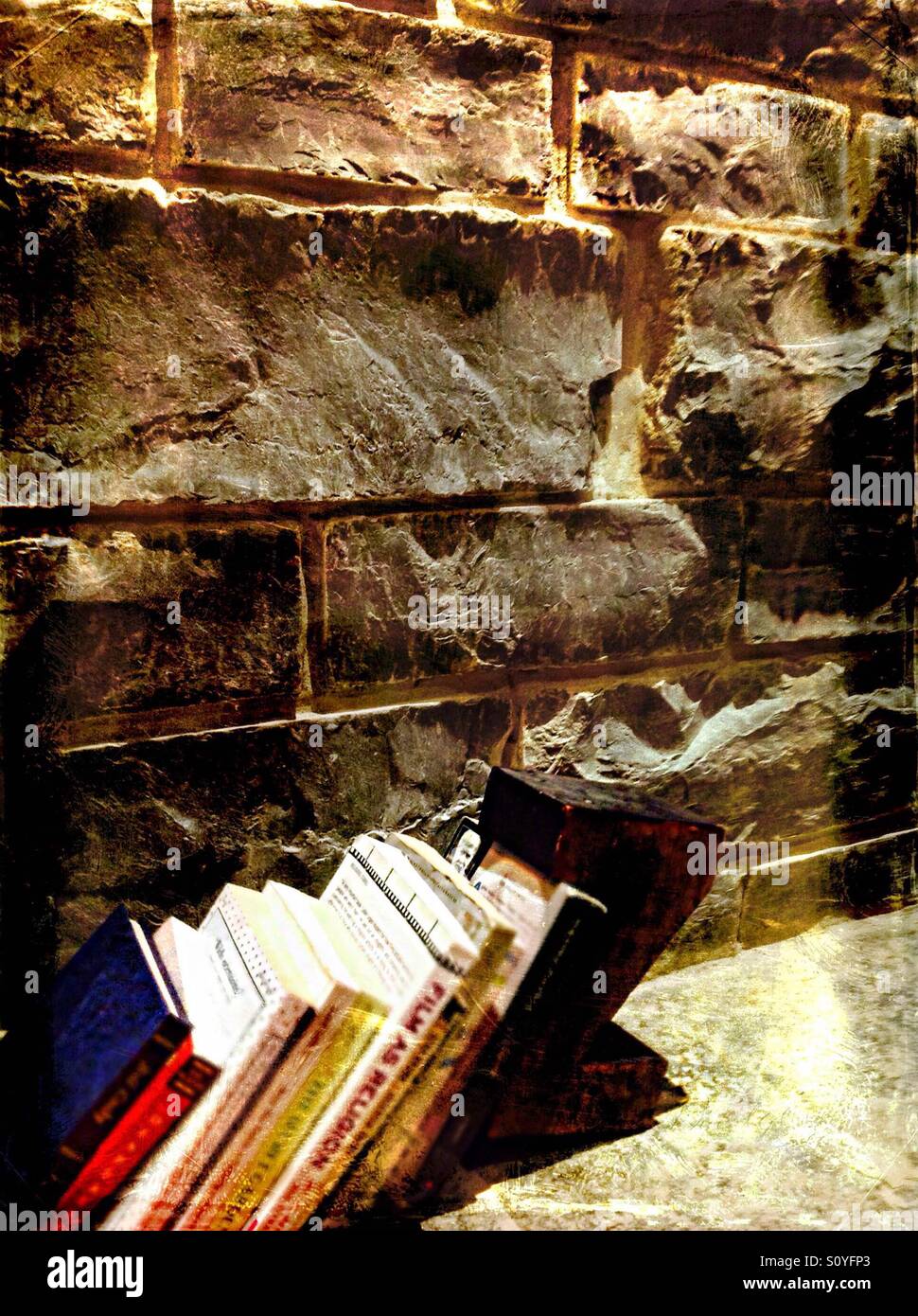 Brick ledge with books and bookend Stock Photo - Alamy