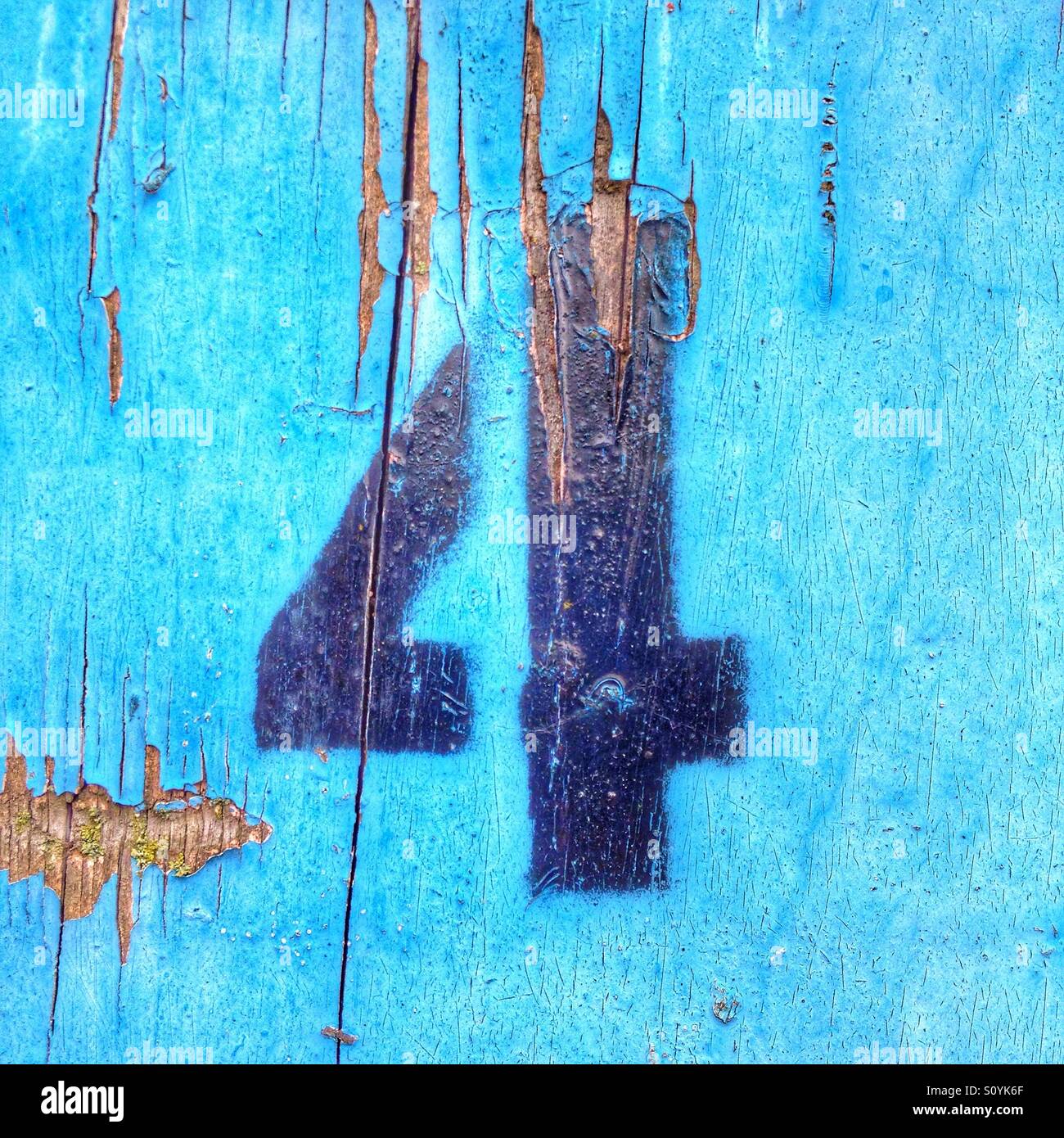 Painted number four on a blue background Stock Photo - Alamy