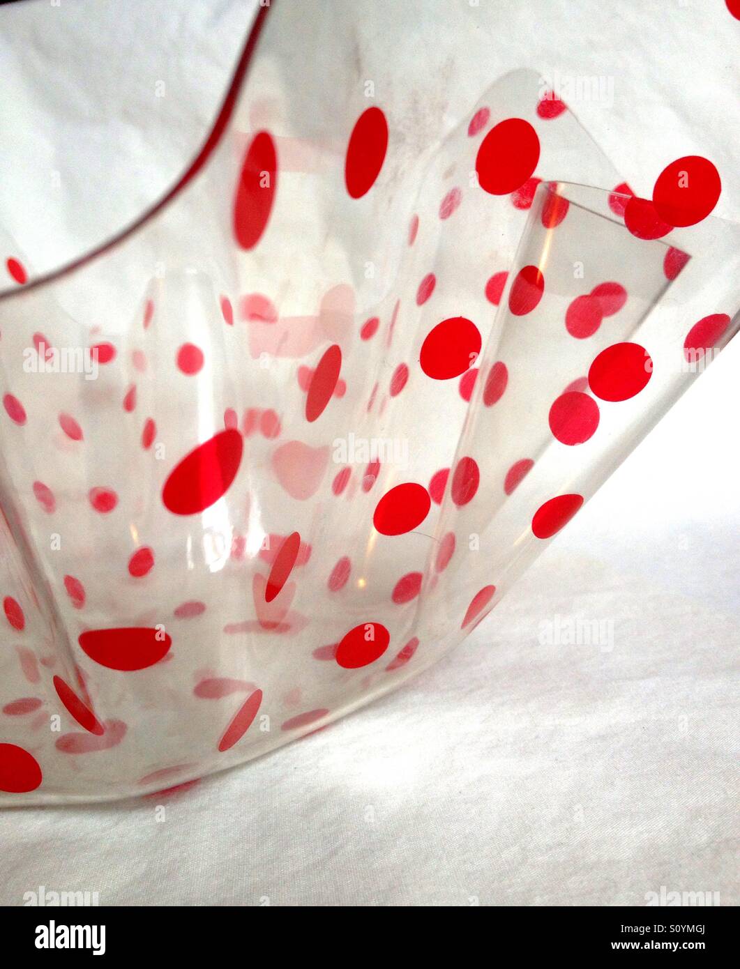 Clear ruffled bowl with red polka dots Stock Photo - Alamy