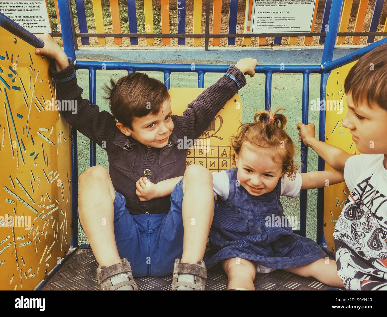 Kids playing in the playground Stock Photo - Alamy