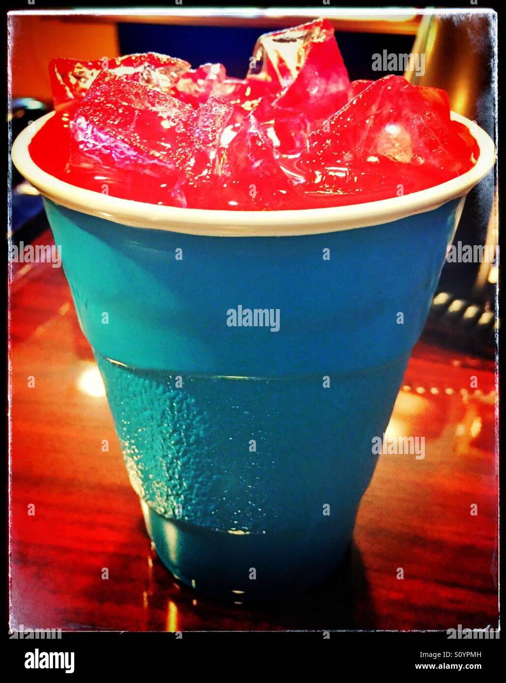Cup of fruit juice on ice in a blue cup Stock Photo - Alamy