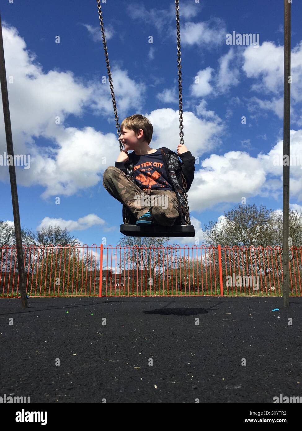 Child swinging high hi-res stock photography and images - Alamy