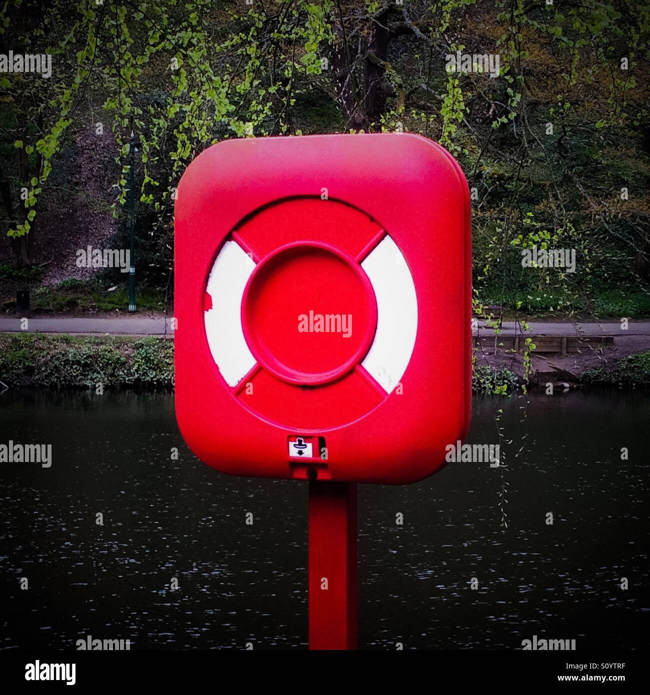 Red life belt safety equipment next to a river in Derbyshire England UK ...
