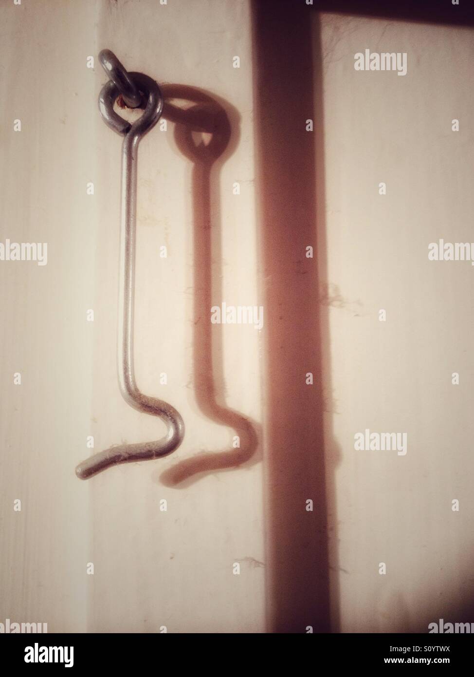 A metal latch attached to a door frame Stock Photo - Alamy