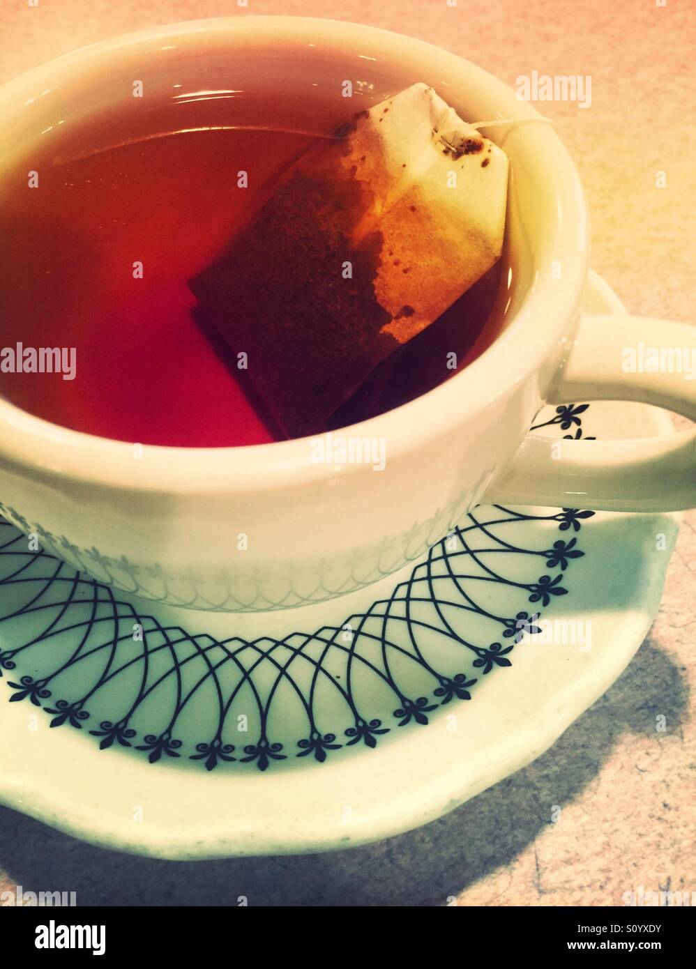 Teabag steeping in a cup of hot water Stock Photo - Alamy