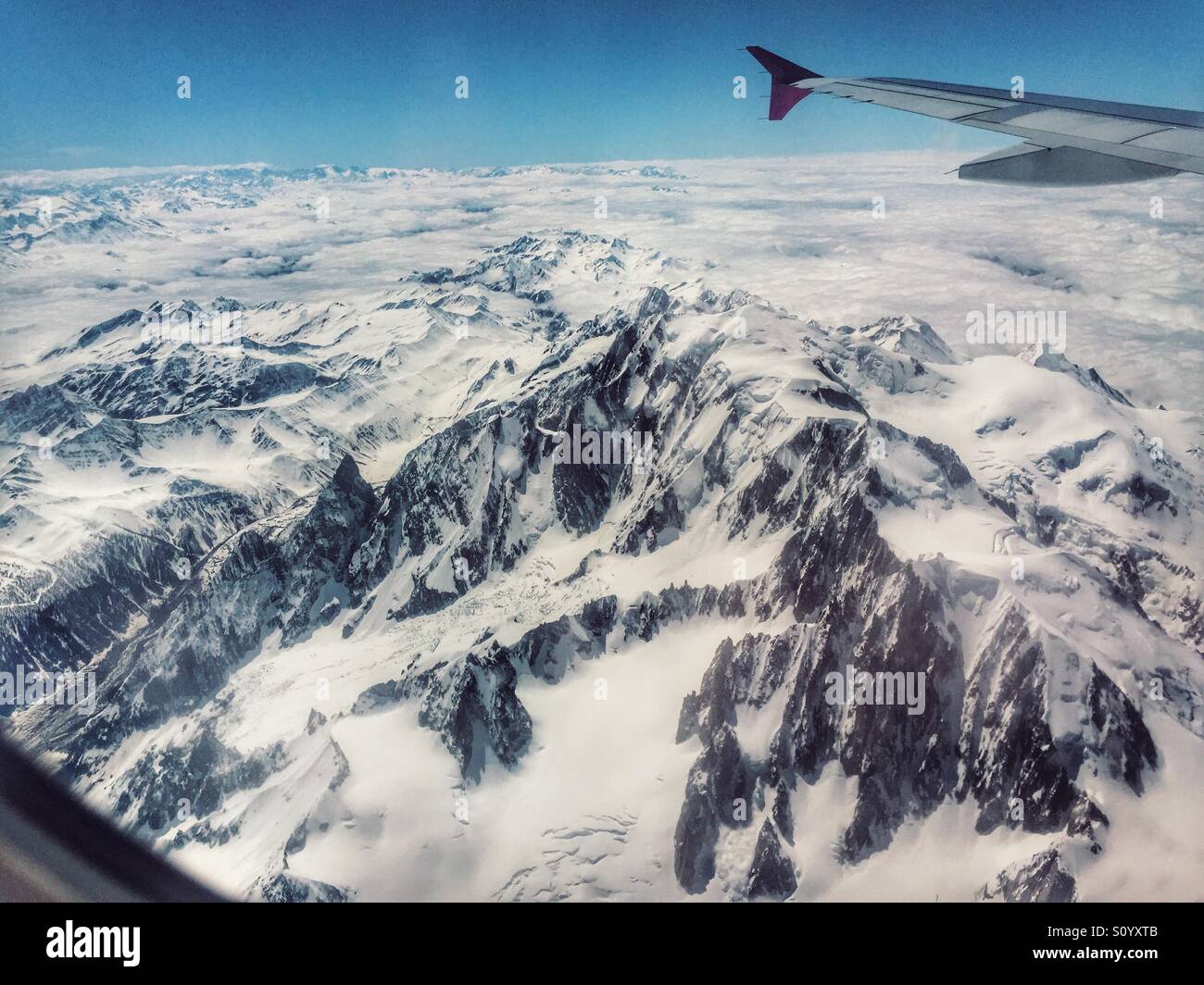 Airplane over mountains in Switzerland Stock Photo - Alamy
