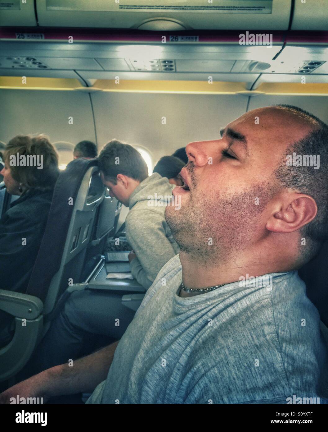 Man sleeping on plane hi-res stock photography and images - Alamy