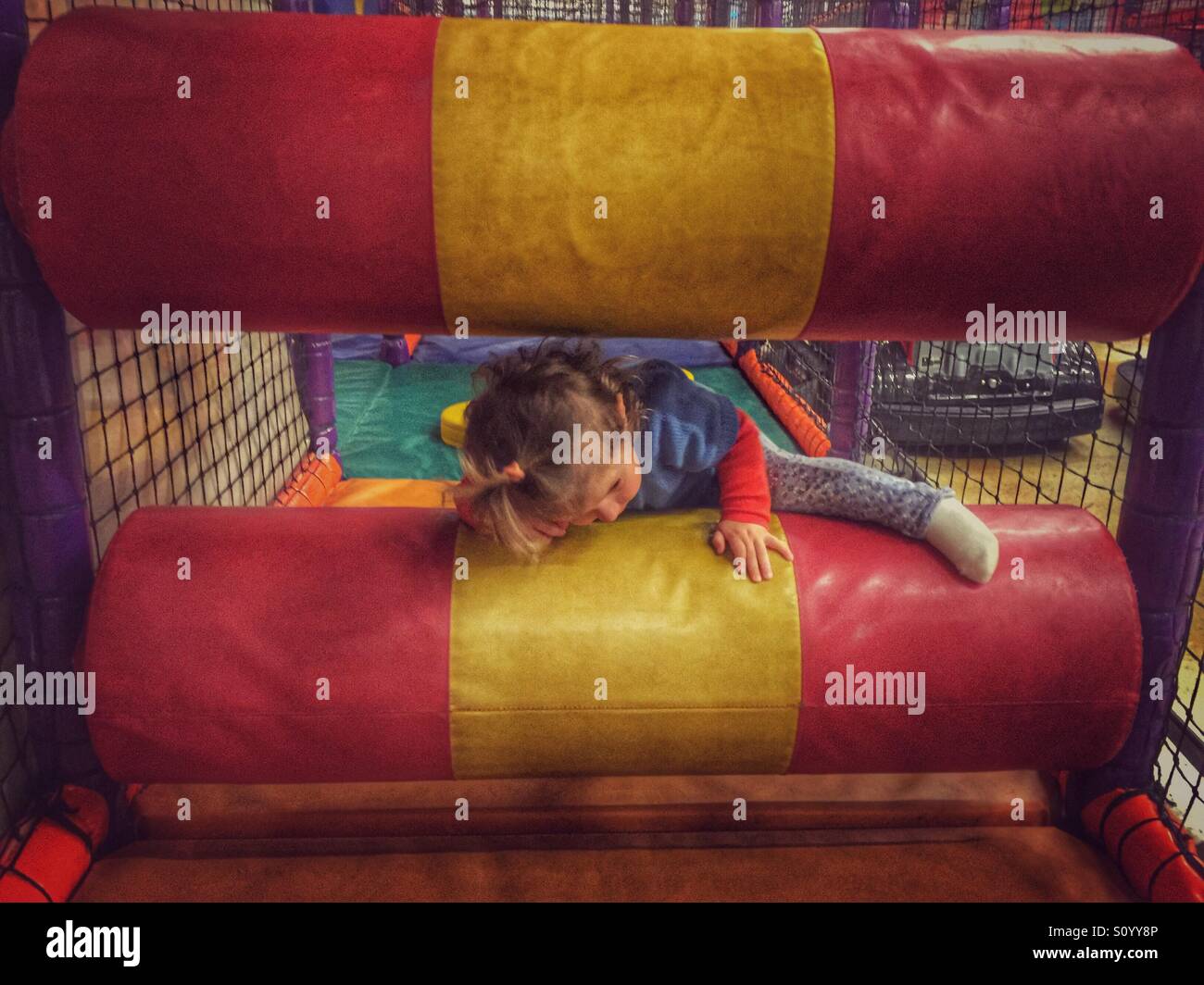 Toddler playing in inside playground Stock Photo - Alamy