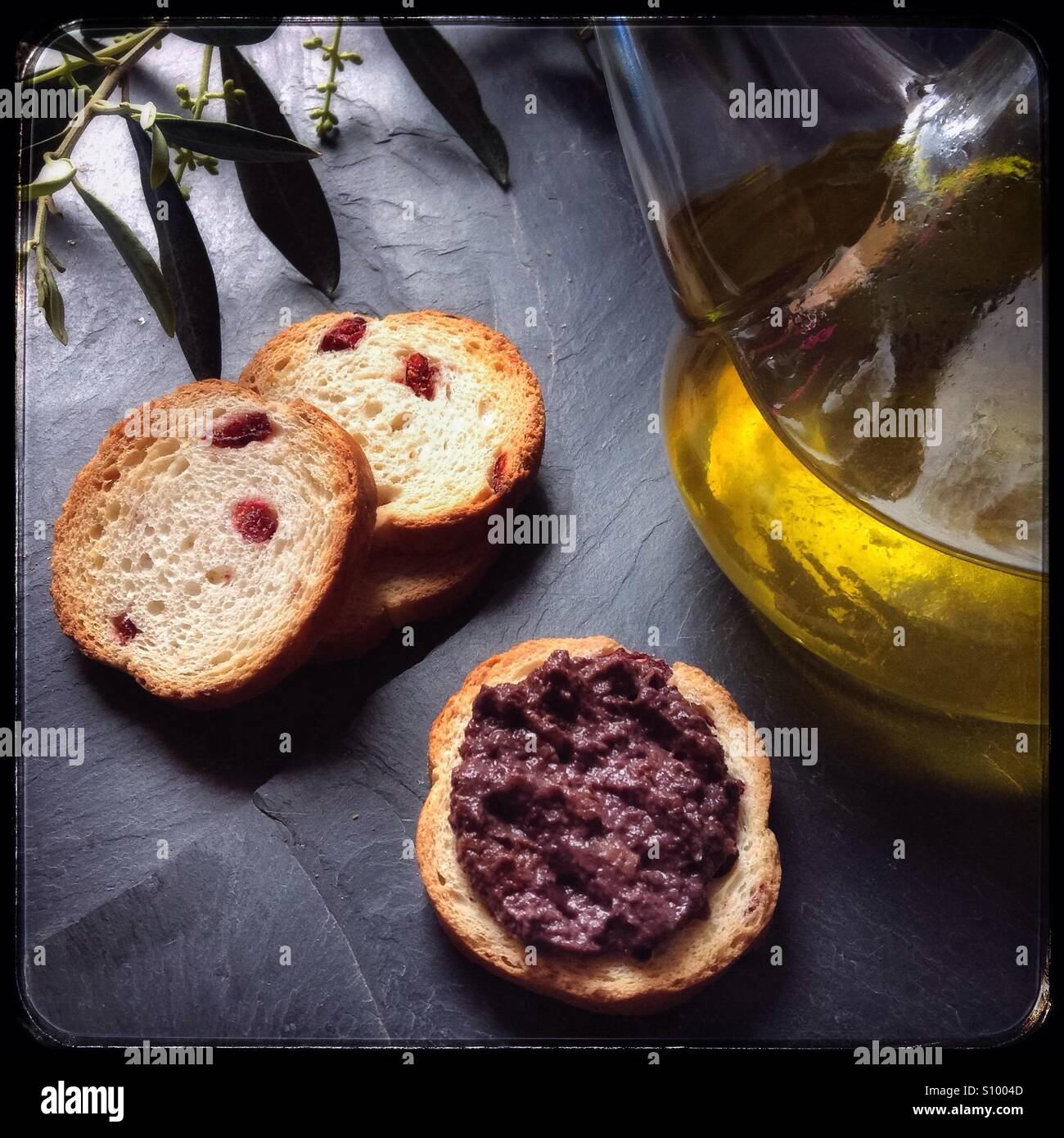 Black-ripened home-cured Spanish Empeltre olive tapenade with a cruet ...