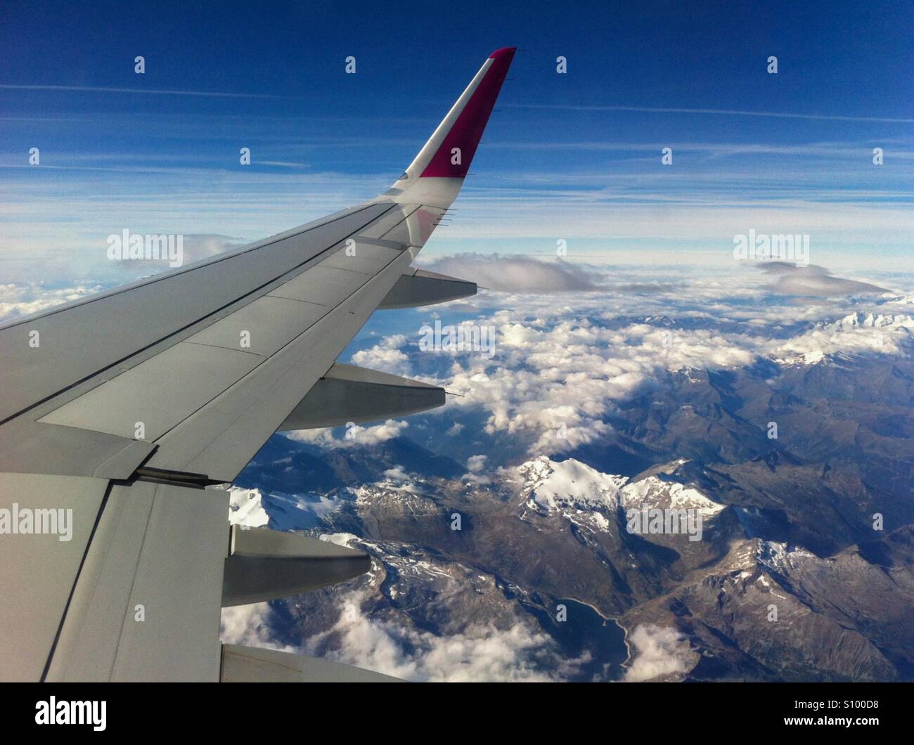 Flying over the mountains. Airplane window view Stock Photo - Alamy