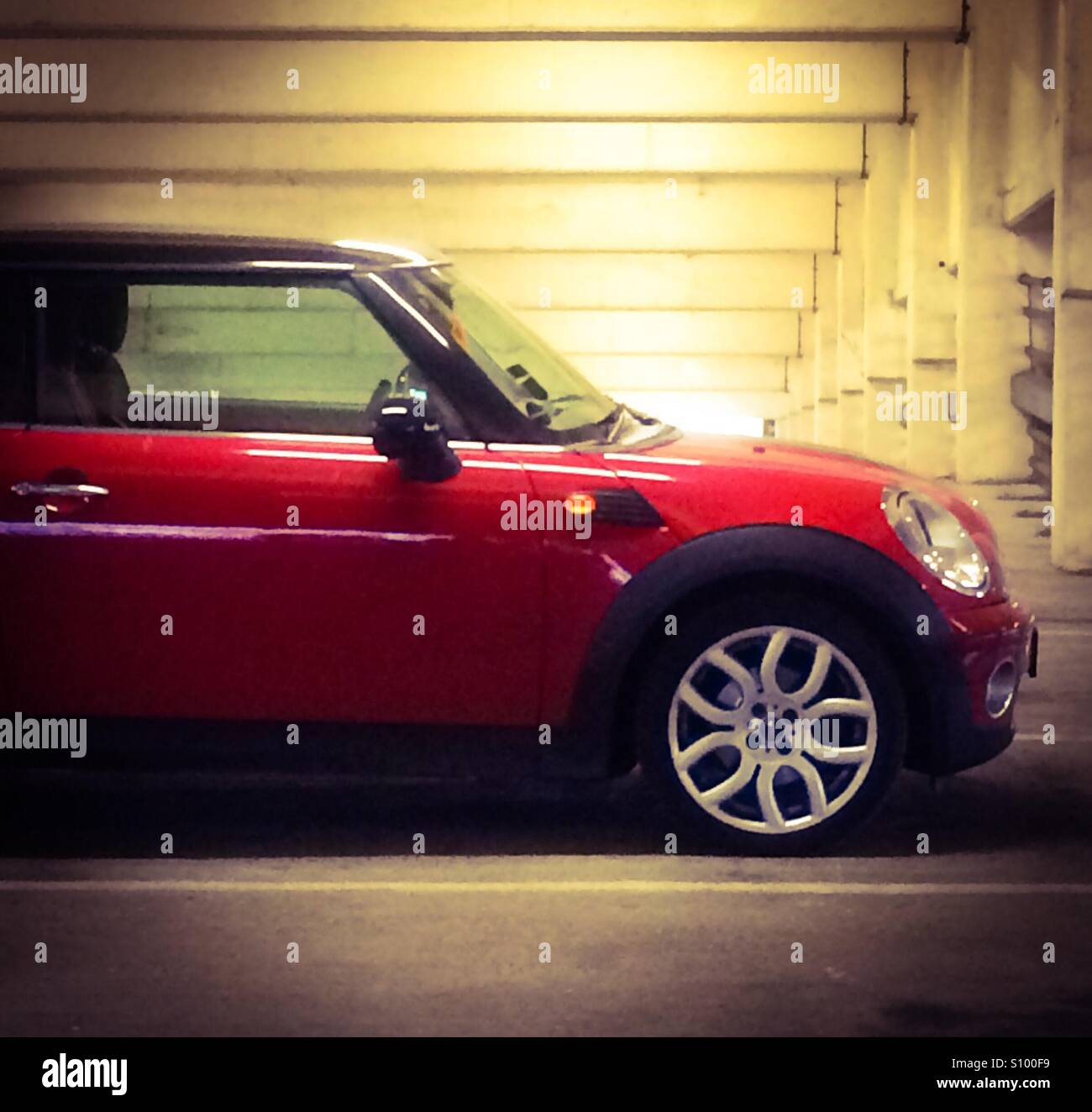 Red mini car parked in a concrete car park Stock Photo - Alamy