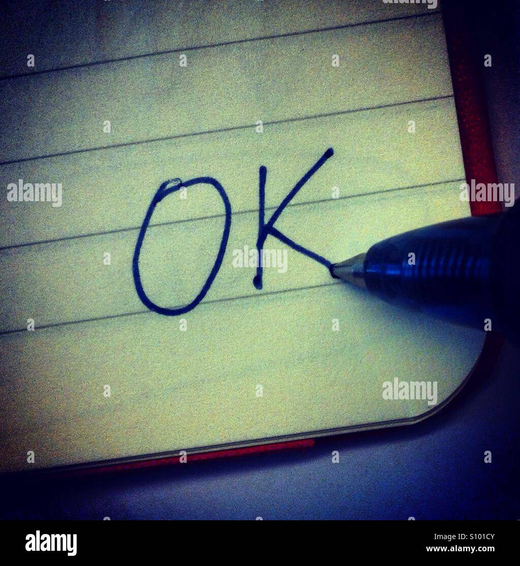 OK written on the corner of a booknote Stock Photo - Alamy