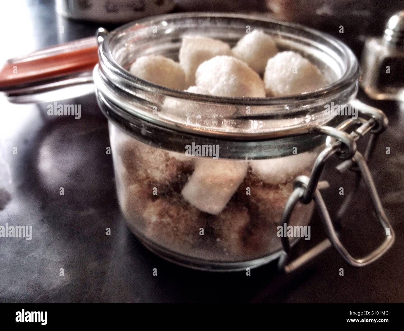 A glass jar containing sugar lumps Stock Photo - Alamy