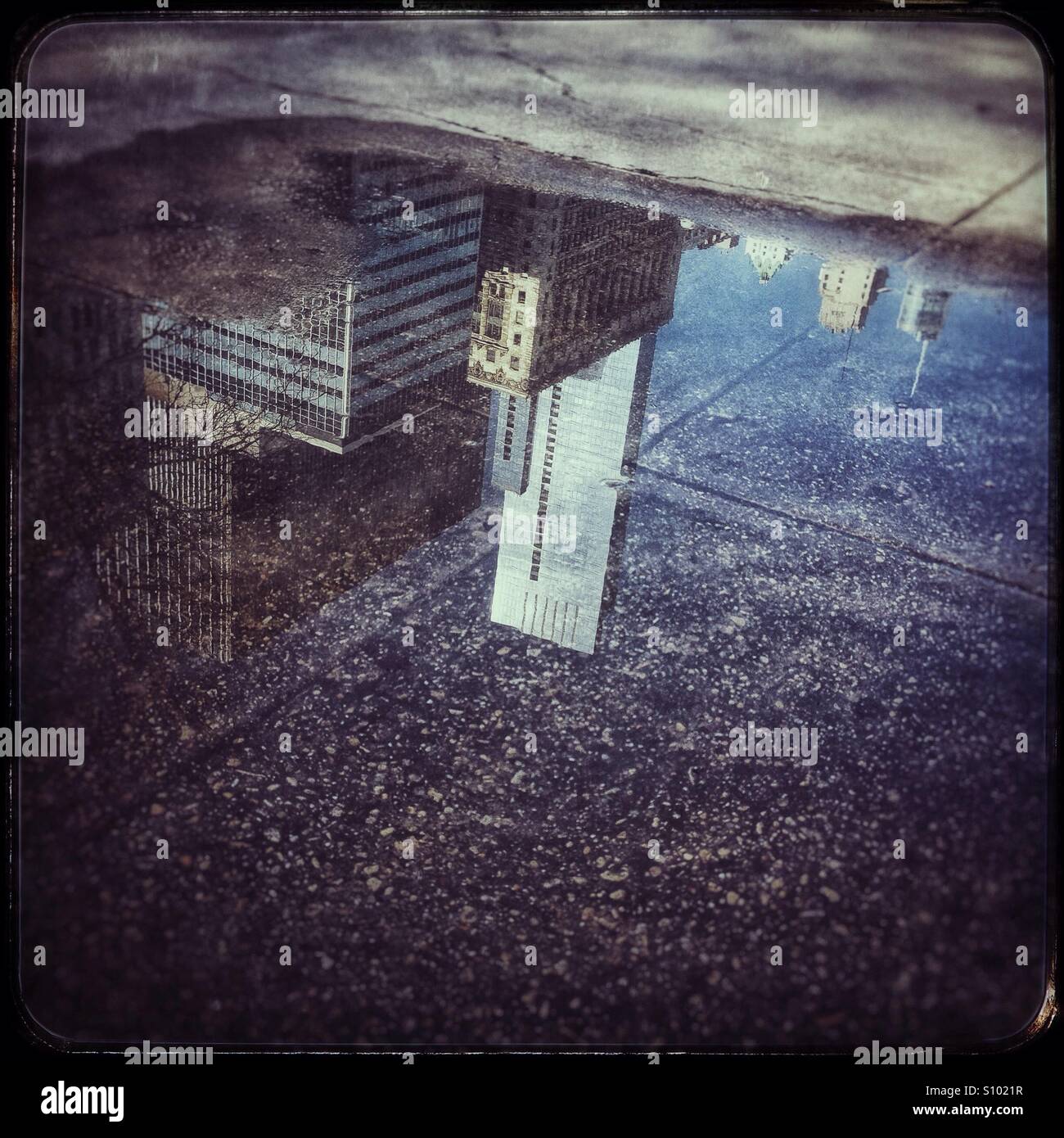 Reflection of modern buildings in puddles Stock Photo - Alamy
