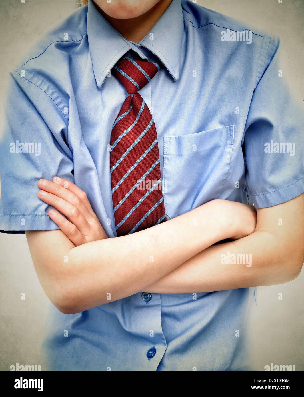 Young girl in her school uniform with folded arms Stock Photo - Alamy