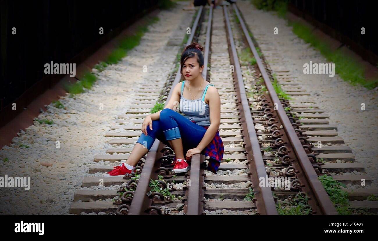Sitting alone on railway line Stock Photo - Alamy
