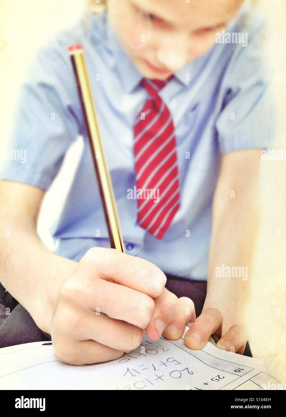 Young girl in school uniform doing her maths homework Stock Photo - Alamy