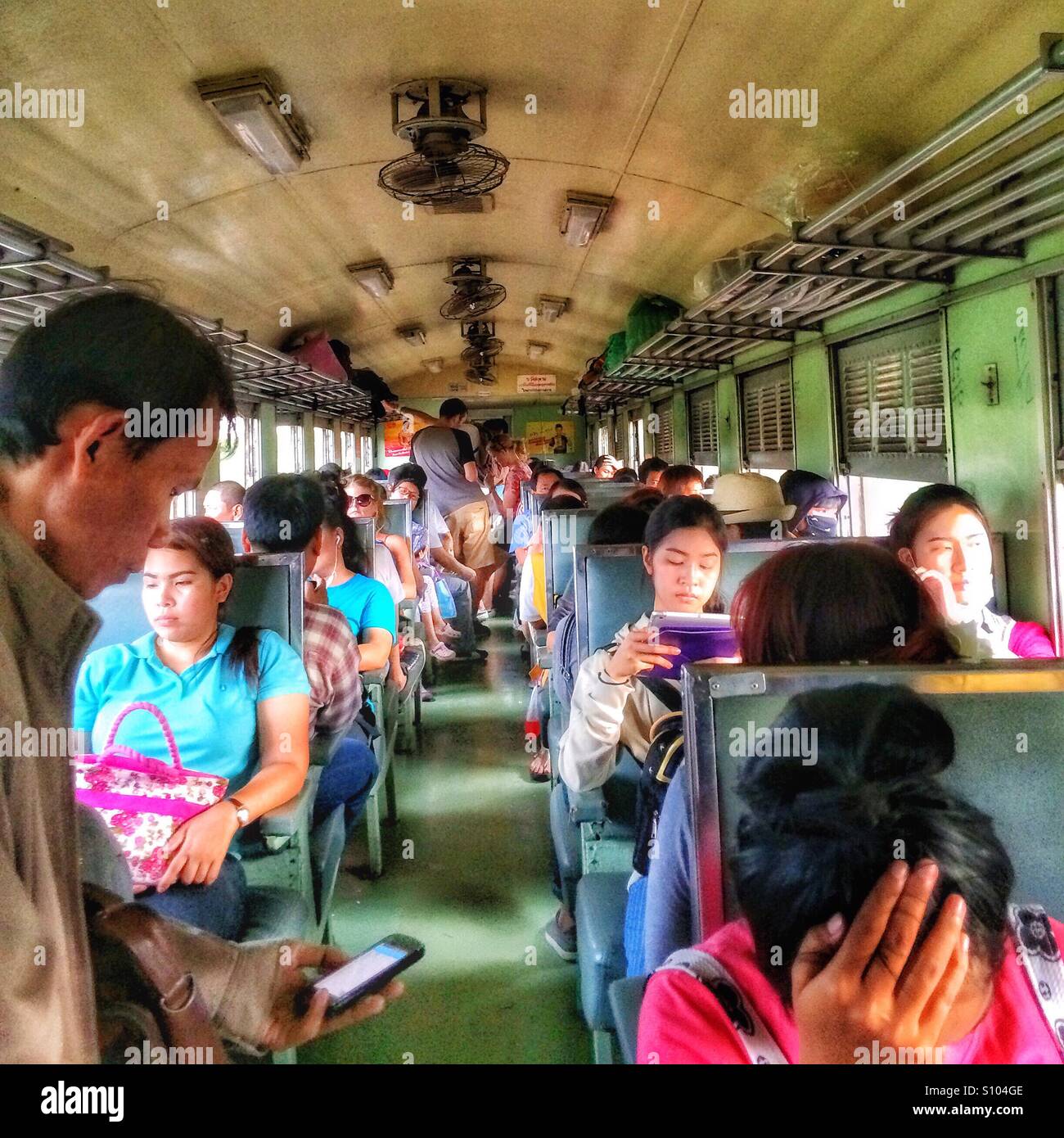 Onboard a crowded third class train in Bangkok, Thailand Stock Photo ...