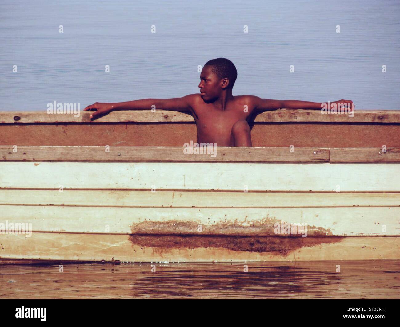 Boy relaxing in fishing boat hi-res stock photography and images - Alamy