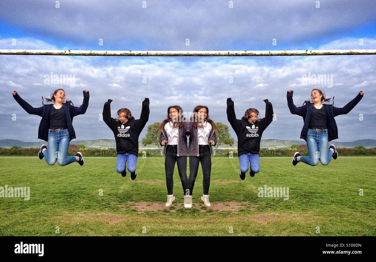 Girls jumping mirrored Stock Photo - Alamy