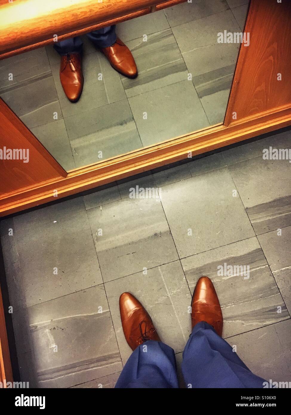 Trying on smart shoes in front of mirror Stock Photo - Alamy