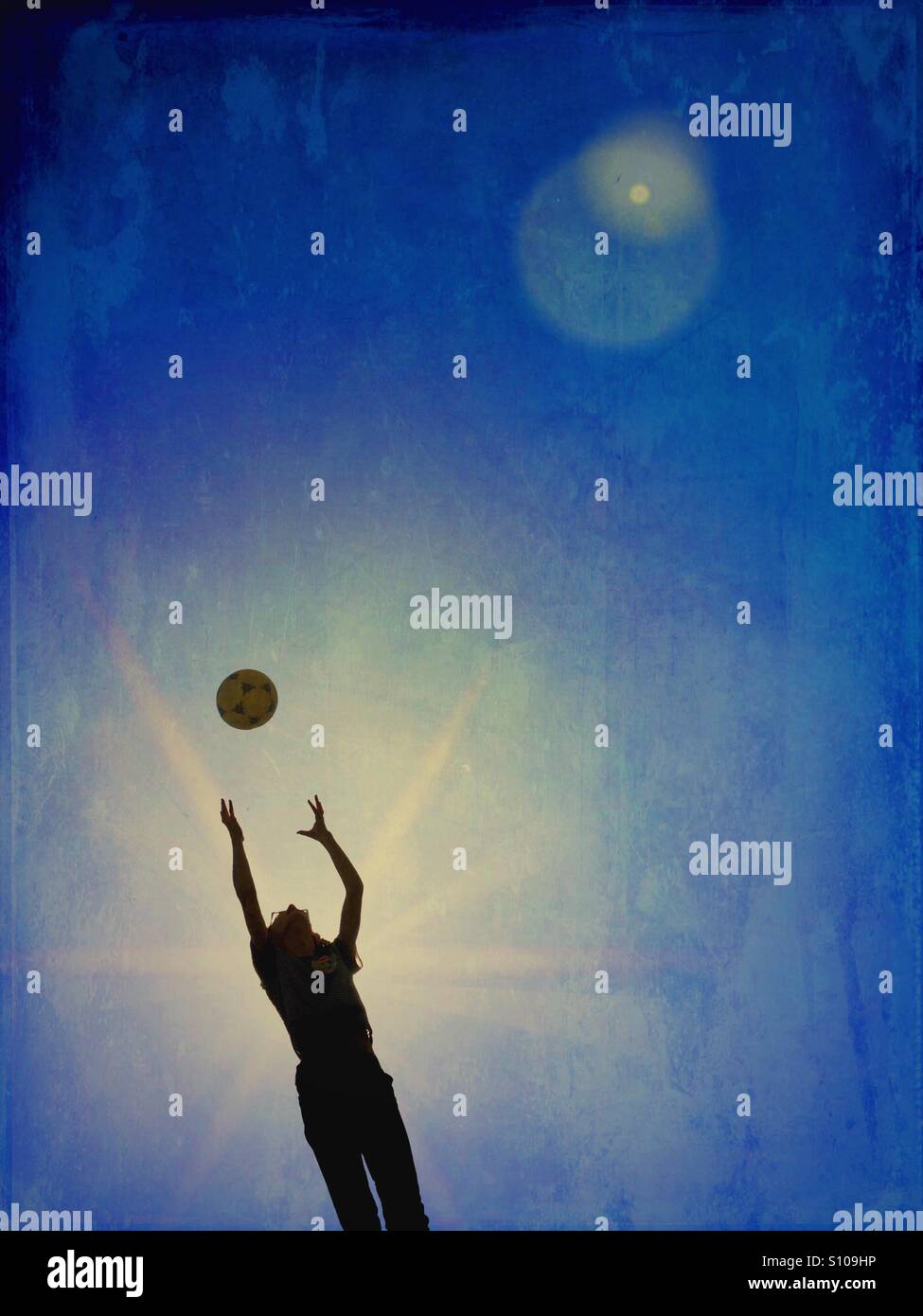 Young girl playing catch with football Stock Photo - Alamy