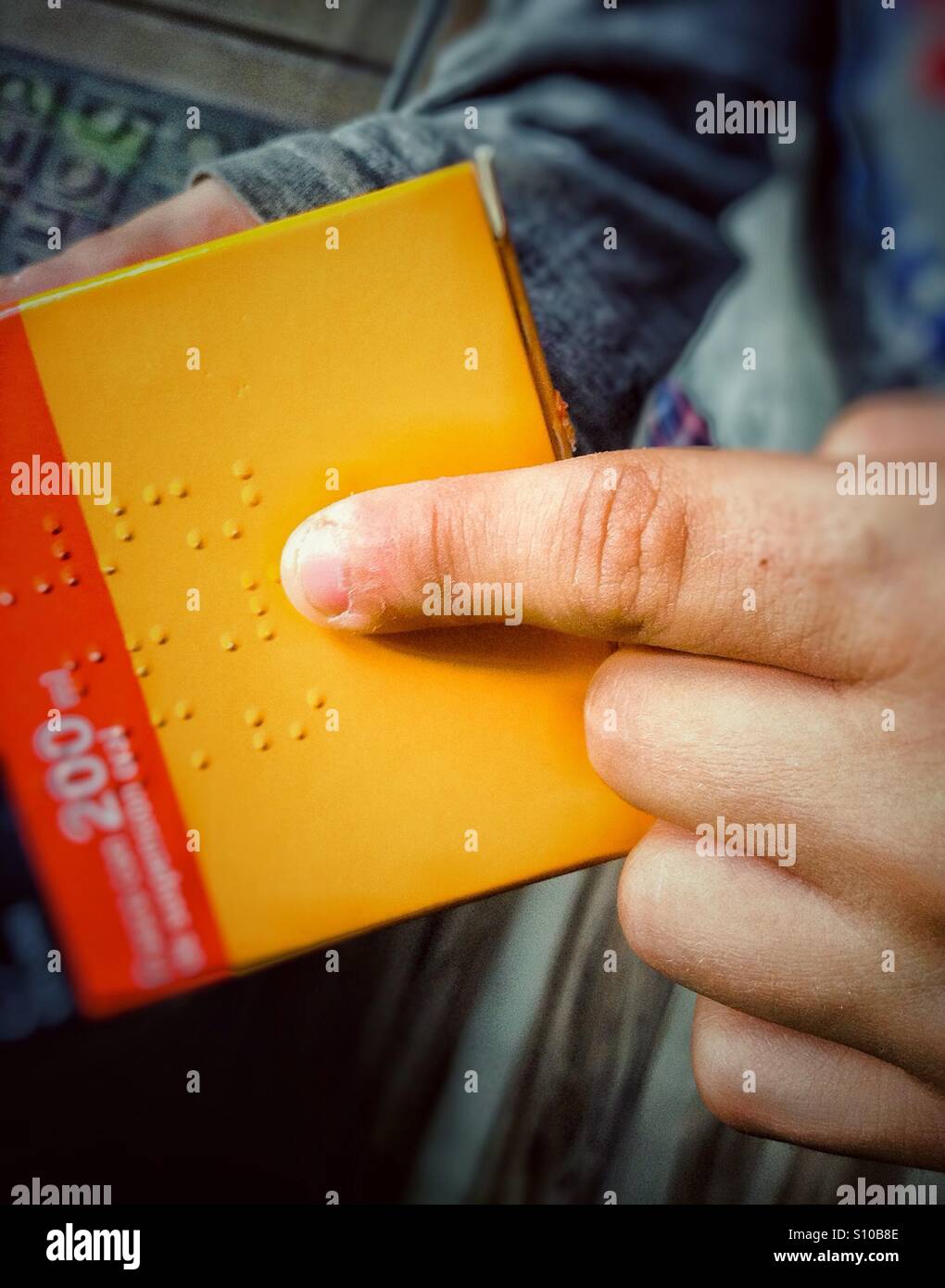 Reading braile raised writing on a medicine prescription packaging ...