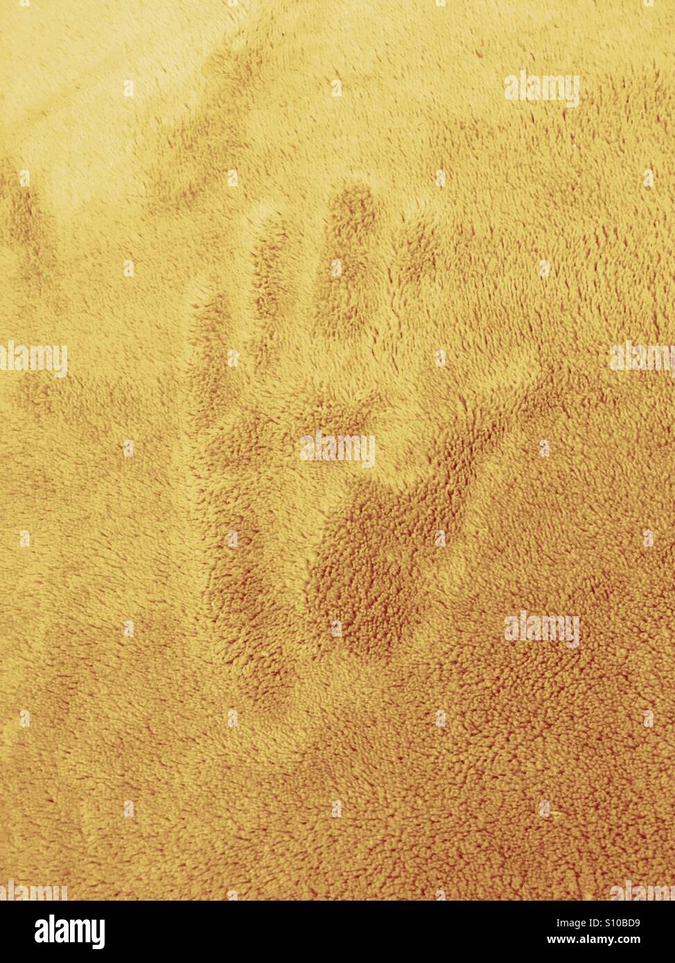 Handprint on yellow texture Stock Photo - Alamy