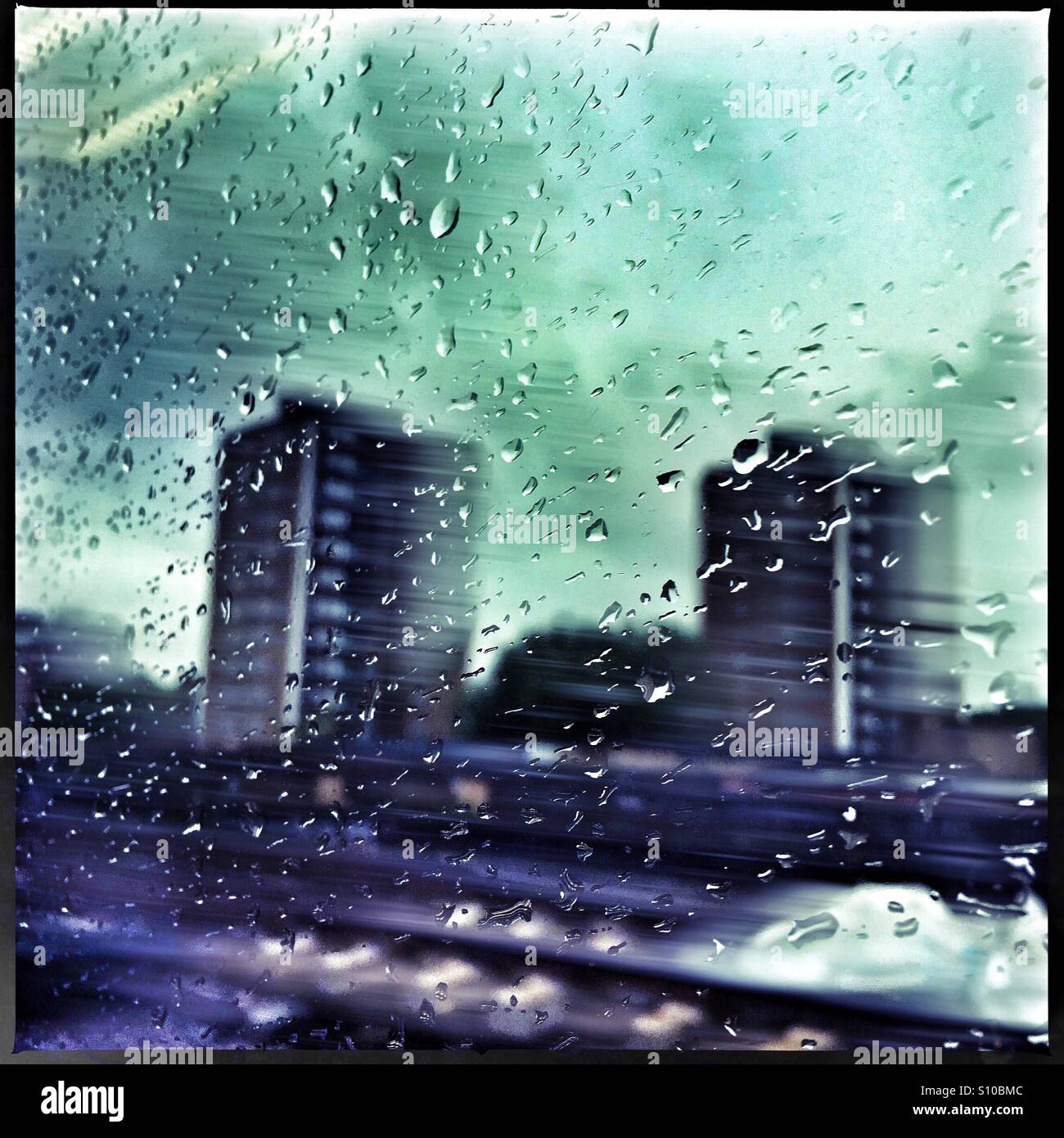 Housing Tower blocks through a rain soaked train window Stock Photo - Alamy