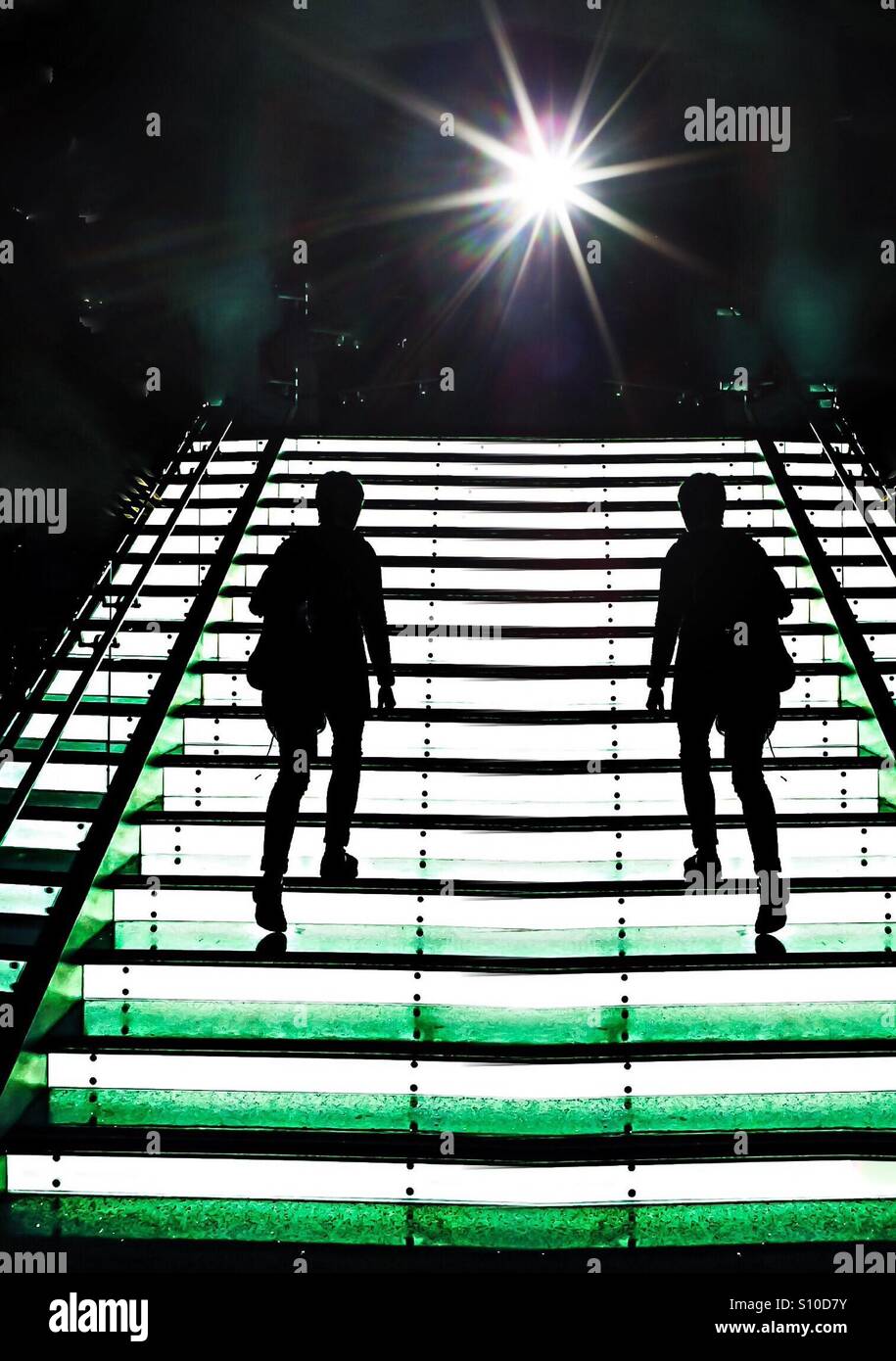 Lone star guiding two people walking up the stairs Stock Photo - Alamy