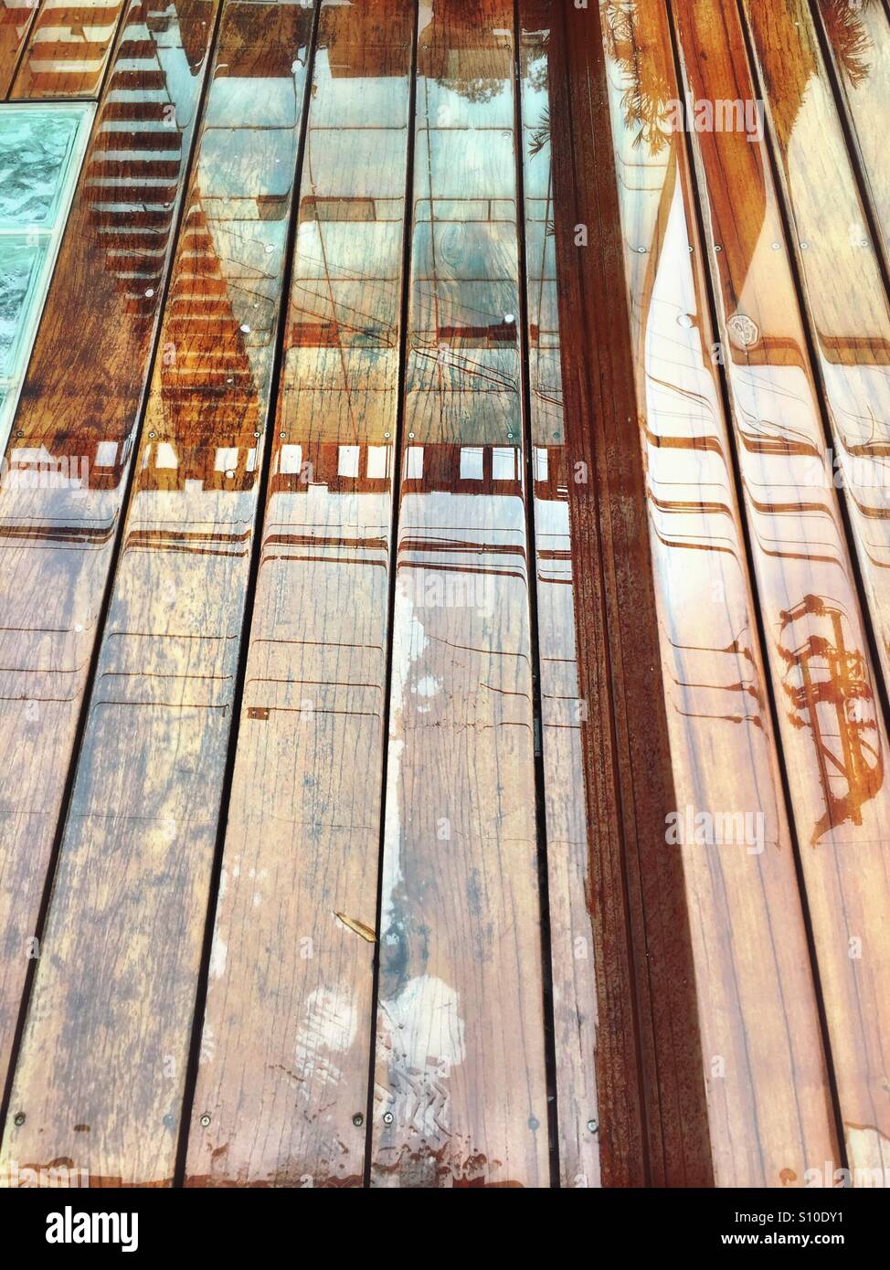 Puddle on wood reflection Stock Photo - Alamy