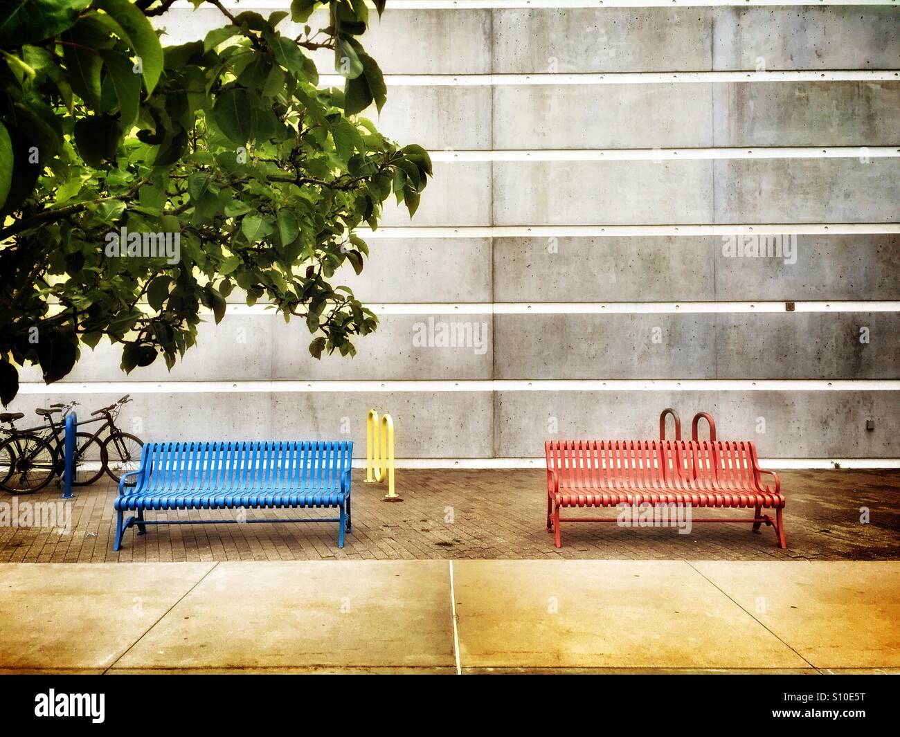 Red and blue benches outside of a museum Stock Photo - Alamy