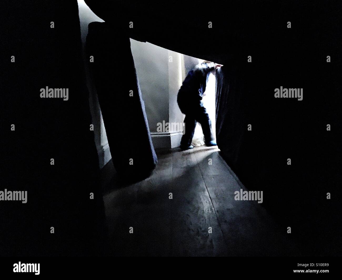 Small boy running away from camera through a tunnel Stock Photo - Alamy