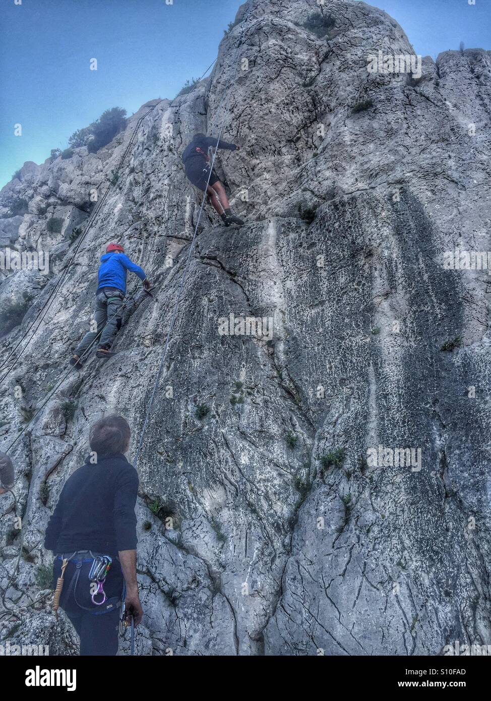 Climbing on rock wall Stock Photo - Alamy